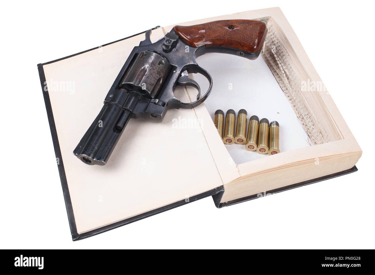 .38 caliber revolver gun with cartridges hidden in a book isolated on ...