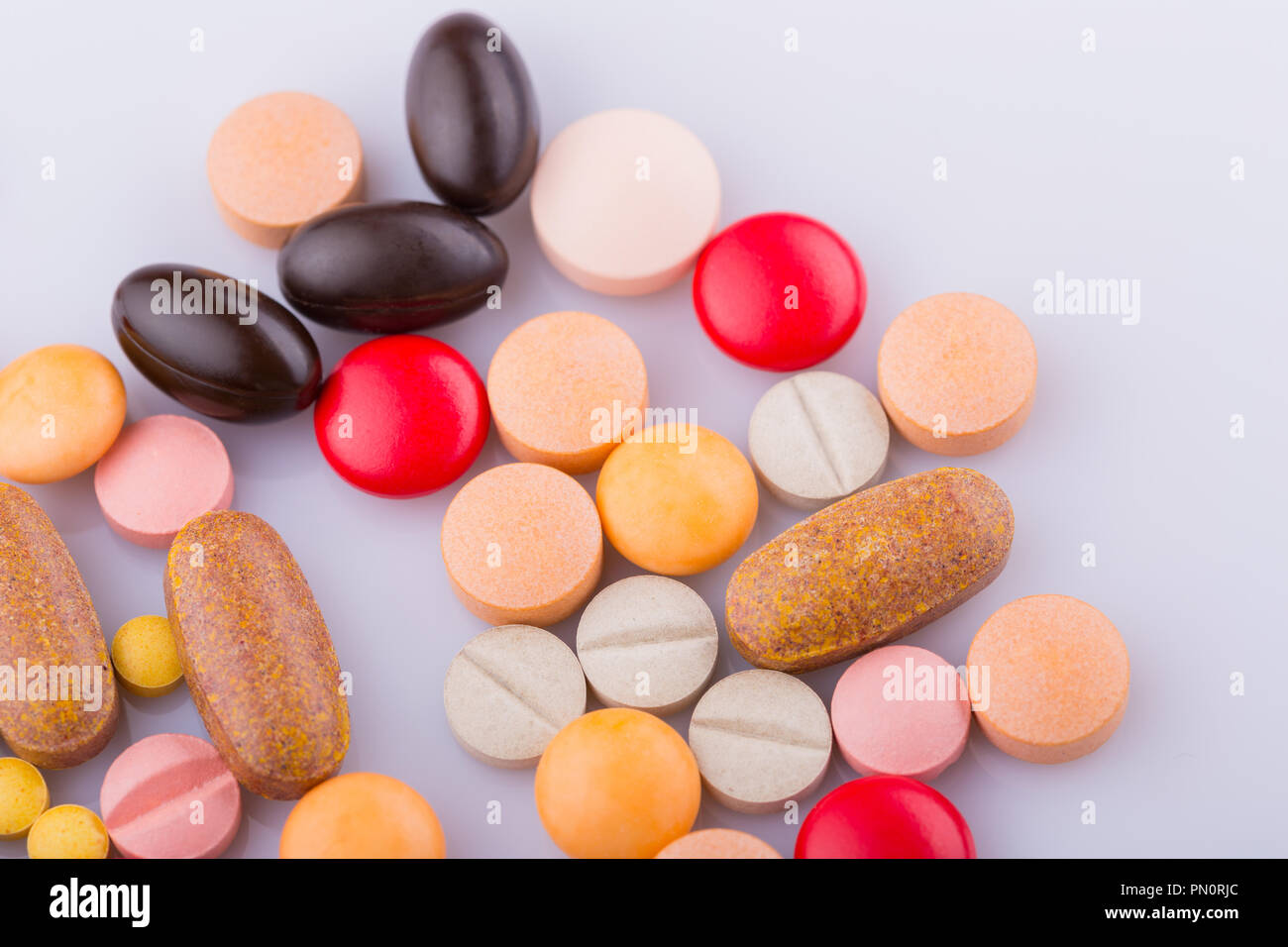 Tablets pills capsule heap mix therapy drugs, over a white background ...