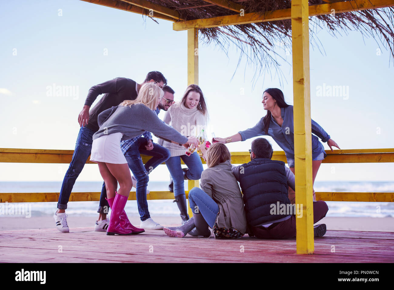 Happy Group Of Friends Hanging Out At Beach House having fun and ...