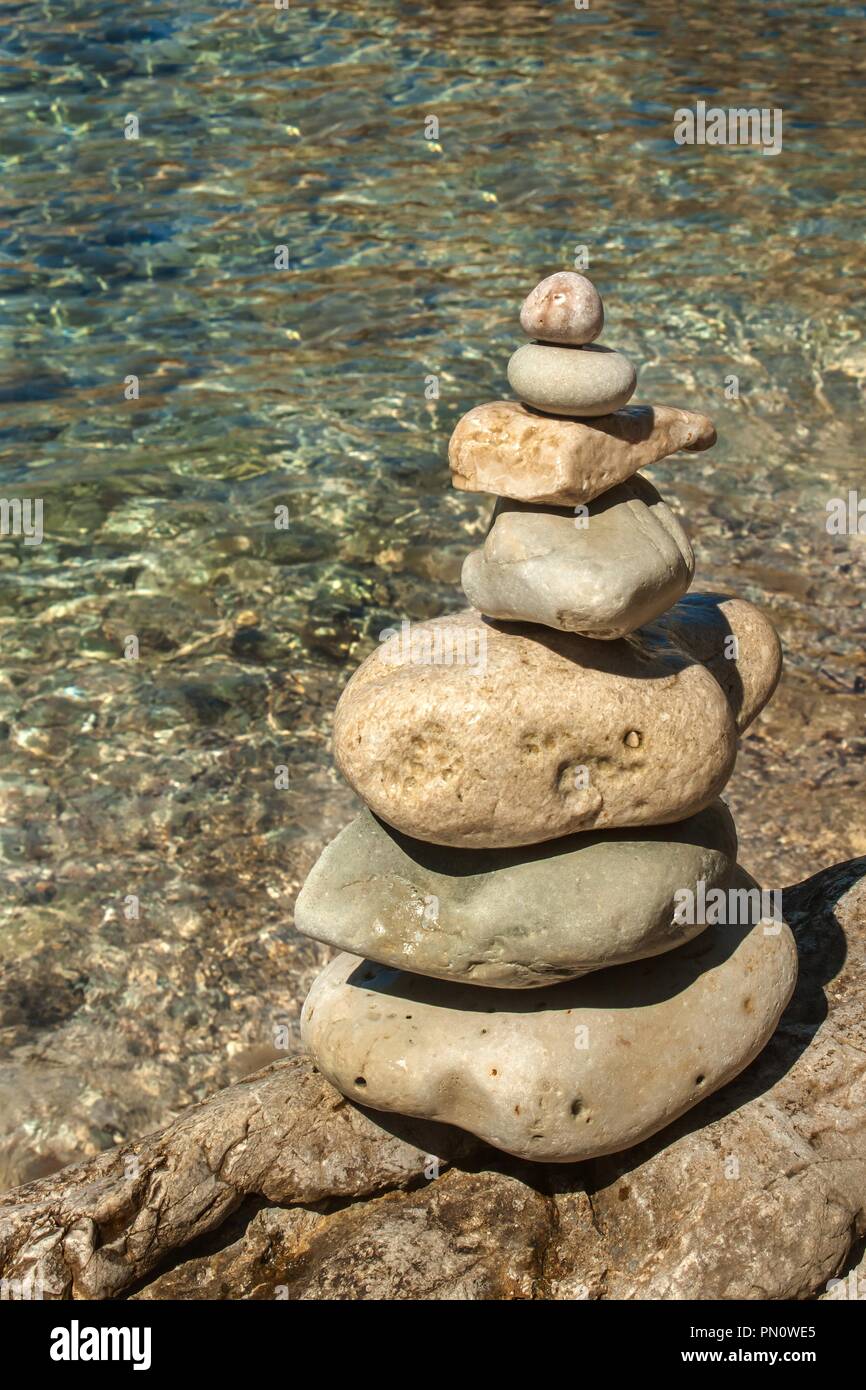 Pile of pebbles on the sea front on a beautiful day. Pebble stack on ...