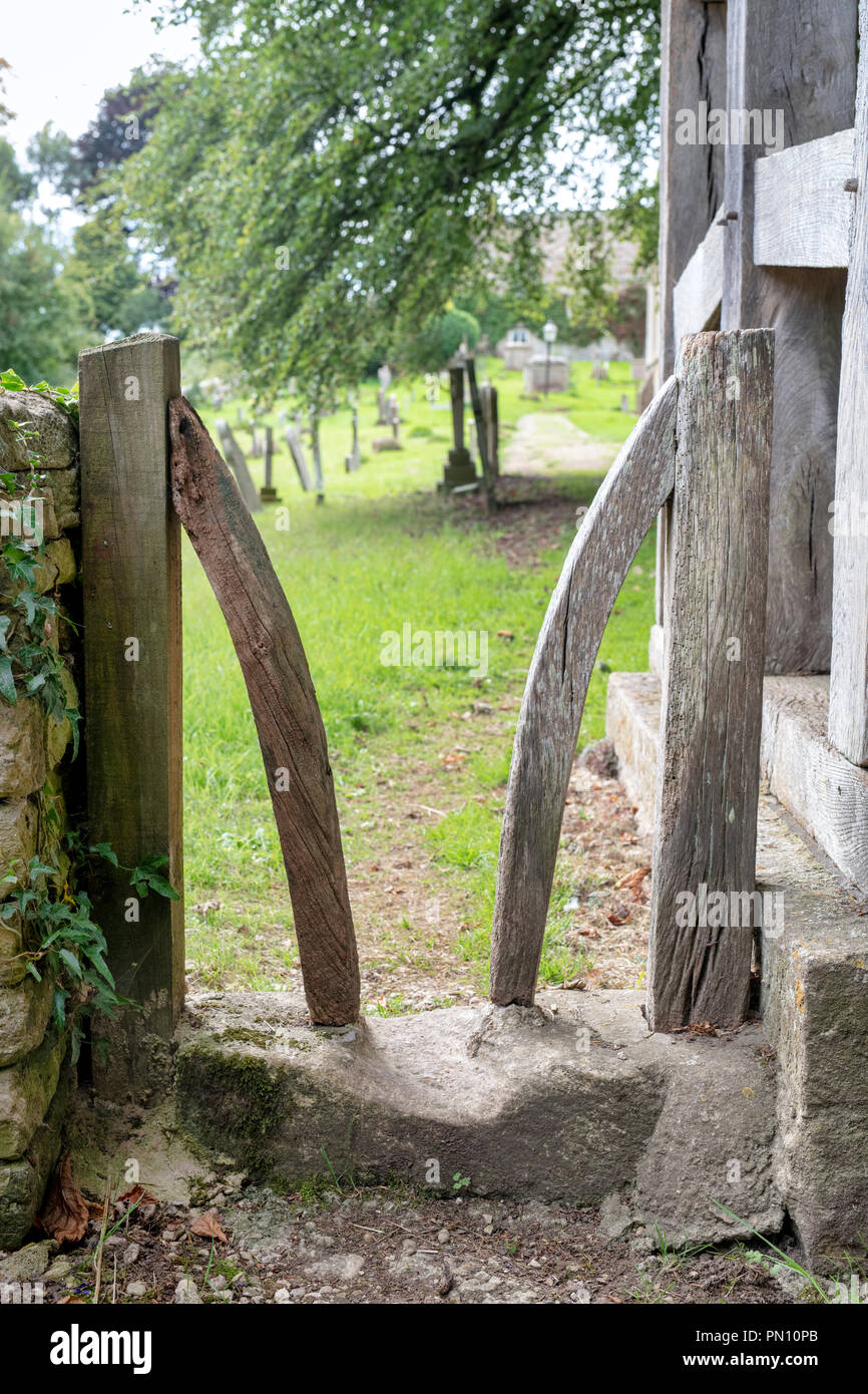 Wooden stile by the lych gate of All Saints church in the village of ...