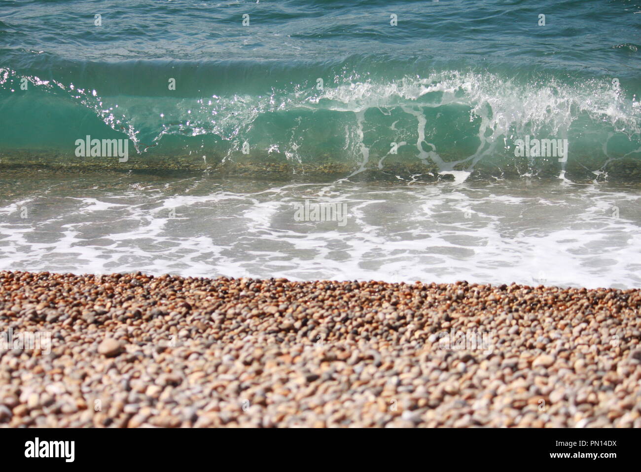 Sea wave on pebble hi-res stock photography and images - Alamy