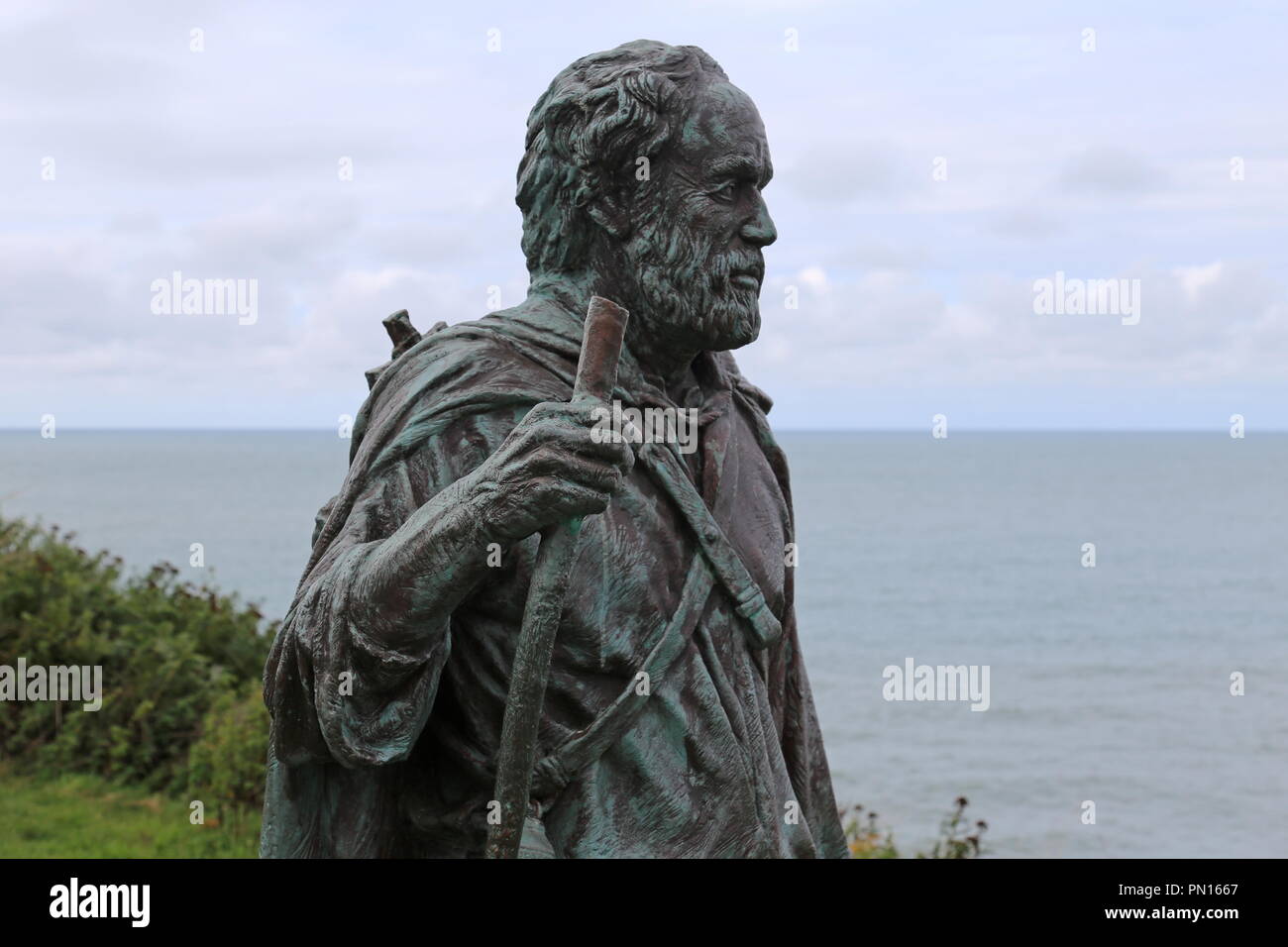 Statue of St Carannog looks down over village he founded. Llangrannog ...