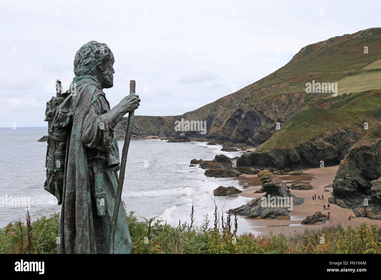 Statue of St Carannog looks down over Bica's Rock. Llangrannog ...