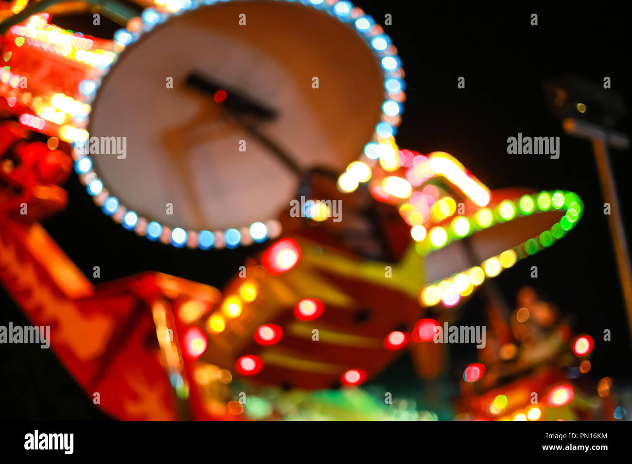 A blurred detail of an illuminated rotating circular device in an ...