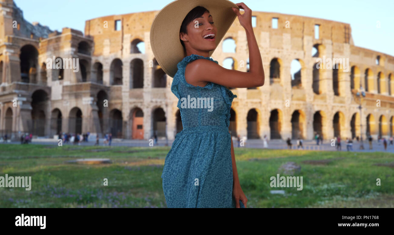 Traveling African-American woman dancing in front of Colosseum in Rome ...