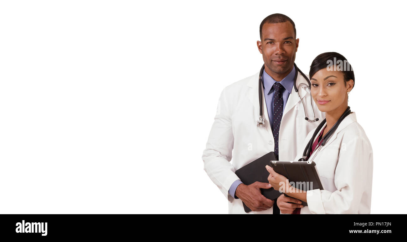 Doctors posing for a portrait while holding their tablets on a white ...