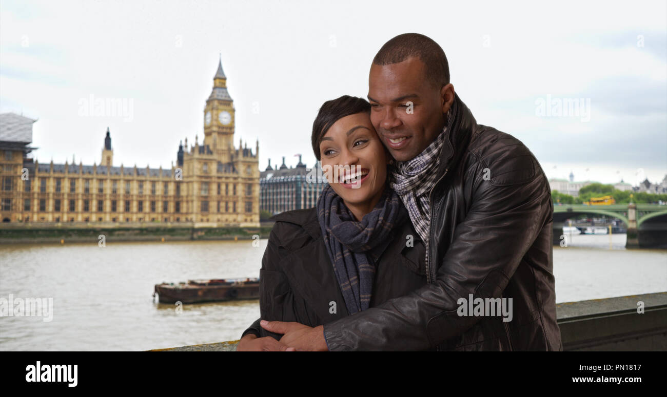 Happy ethnic couple enjoy themselves in London with Big Ben in ...