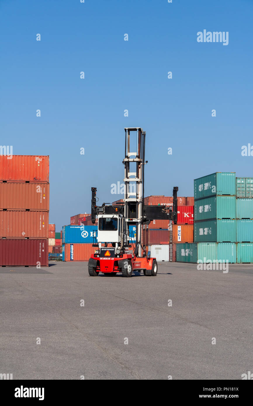 Shipping containers and container forklift Stock Photo - Alamy