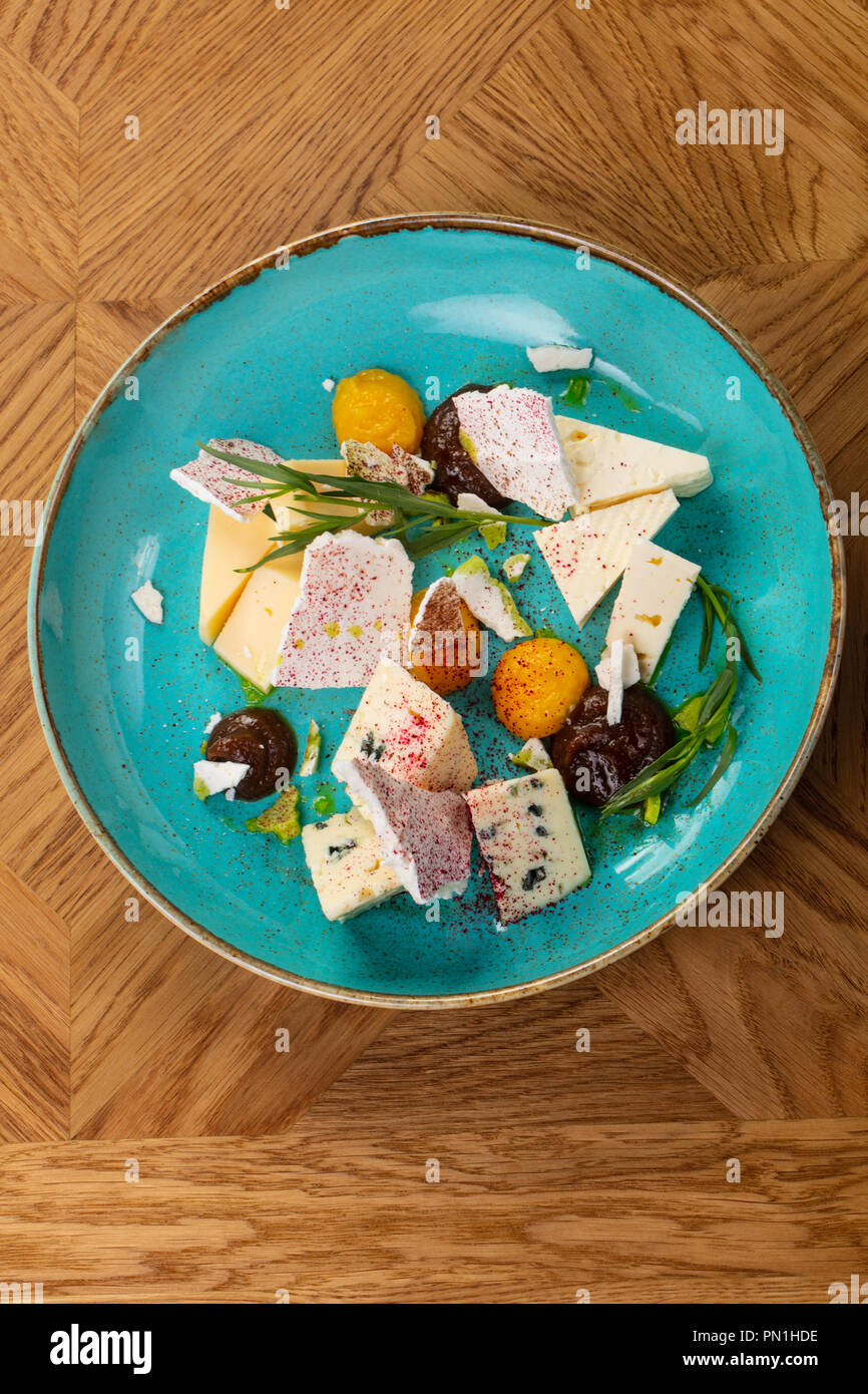 Cheeses plate mix served estragon Stock Photo - Alamy