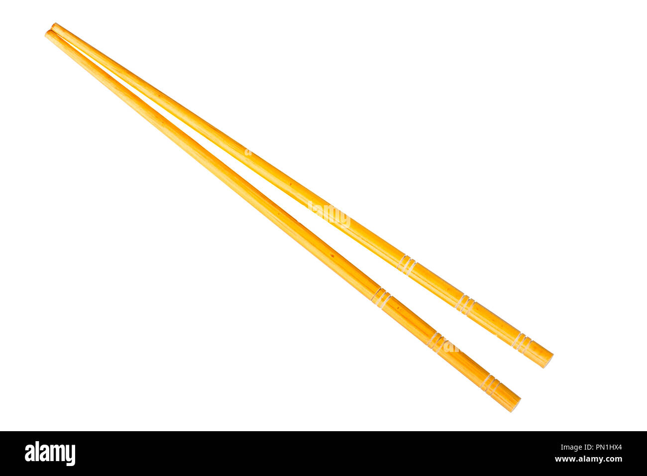 Yellow chopsticks isolated on white background Stock Photo - Alamy