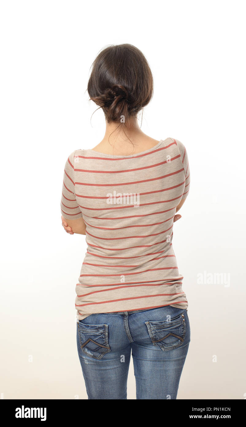 Brunette woman crossing hands and standing back to camera Stock Photo ...
