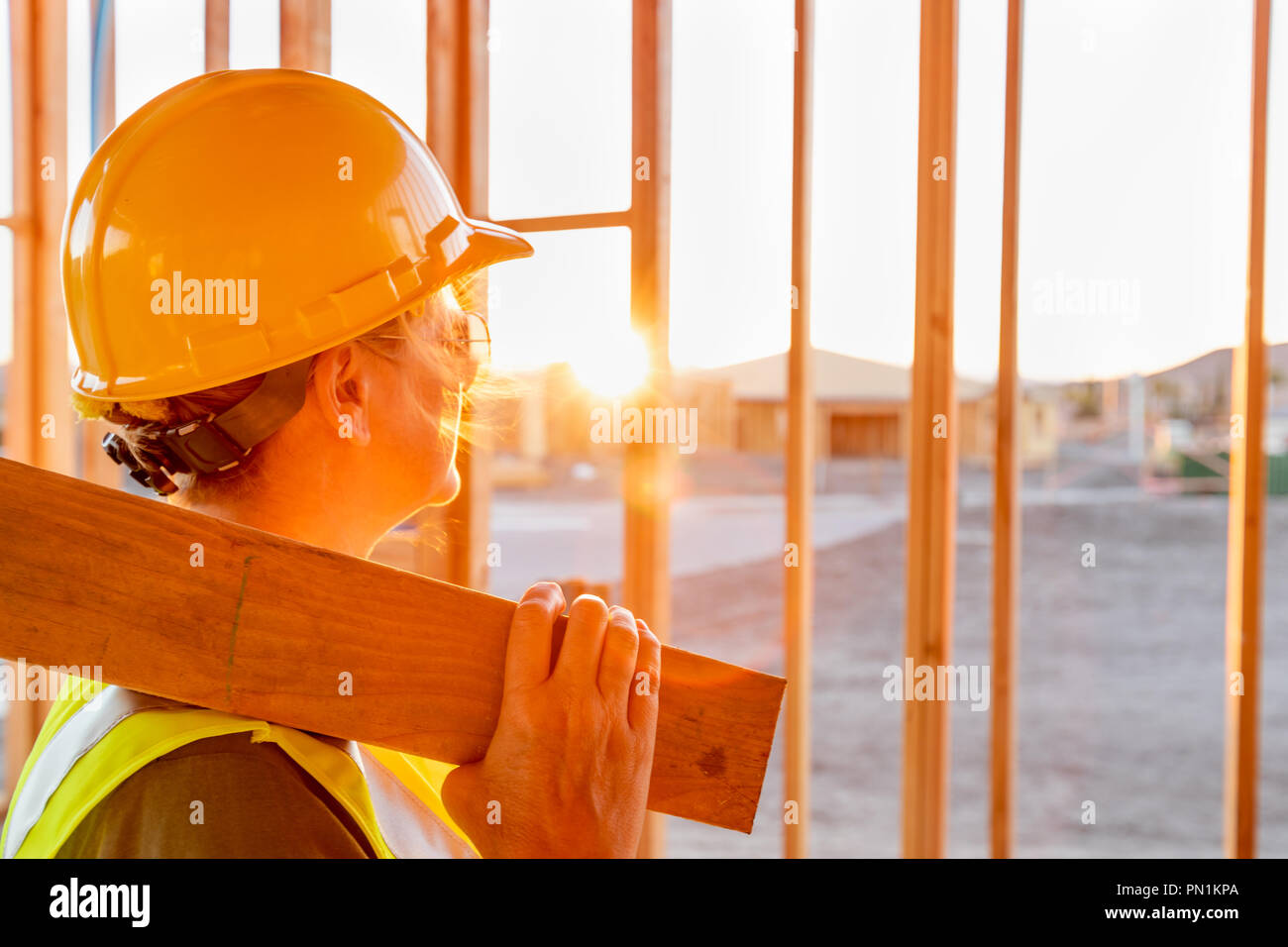 Female Construcion Worker Looking Out From New Home Framing Stock Photo ...