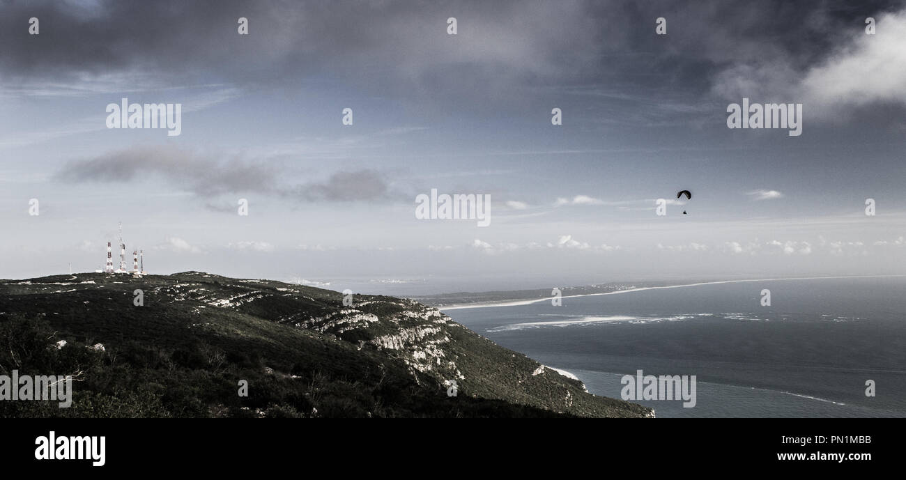 A parachute flies away from the coast Stock Photo - Alamy