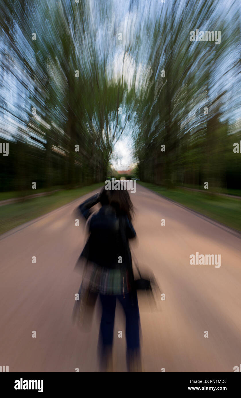A woman is engulfed by a vortex in a city park Stock Photo - Alamy