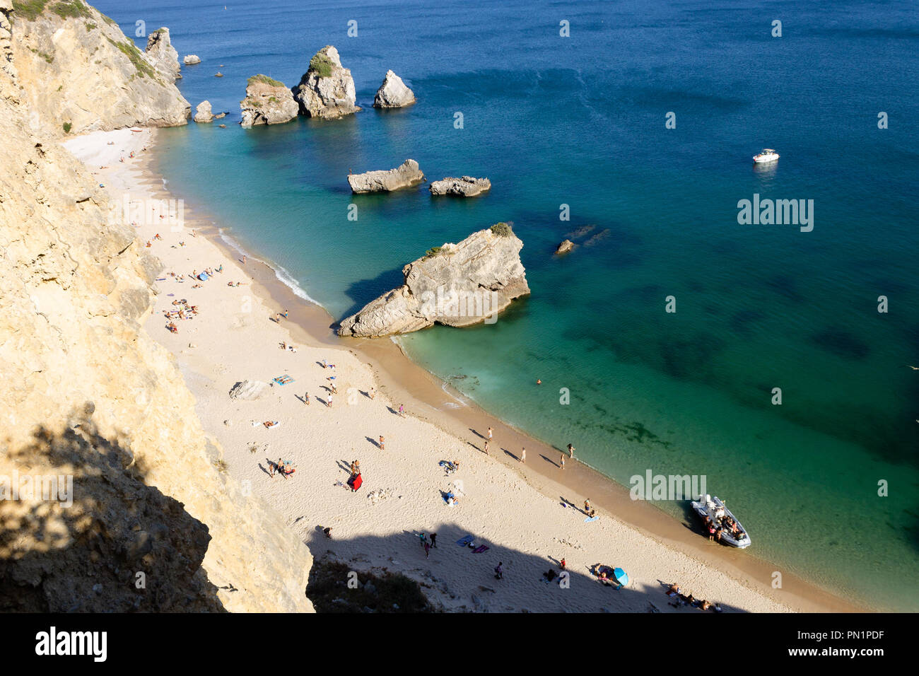 A wide-angle top-view from several people on the beach with various ...
