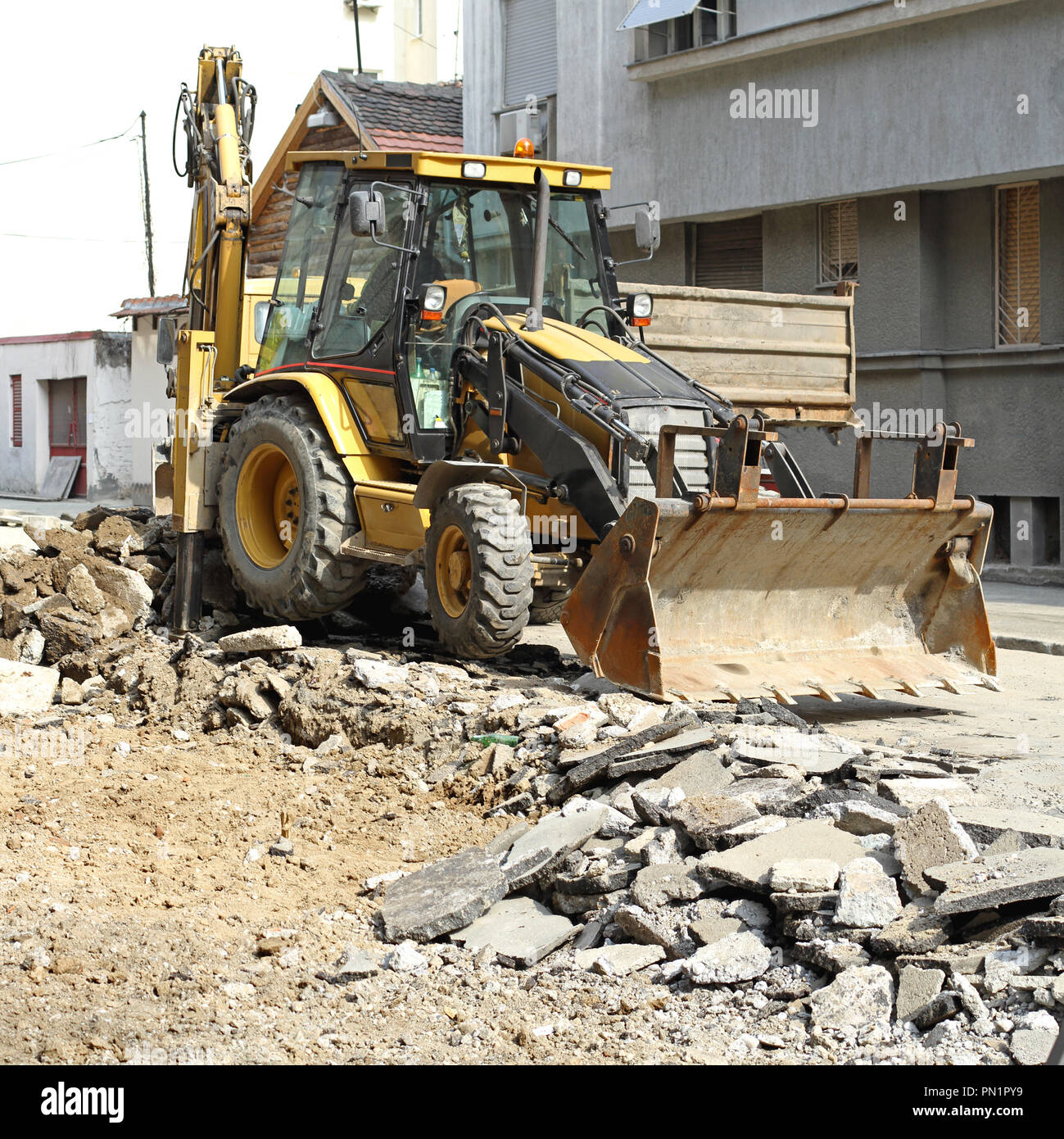 Digging Street With Backhoe Loader at Construction Site Stock Photo - Alamy