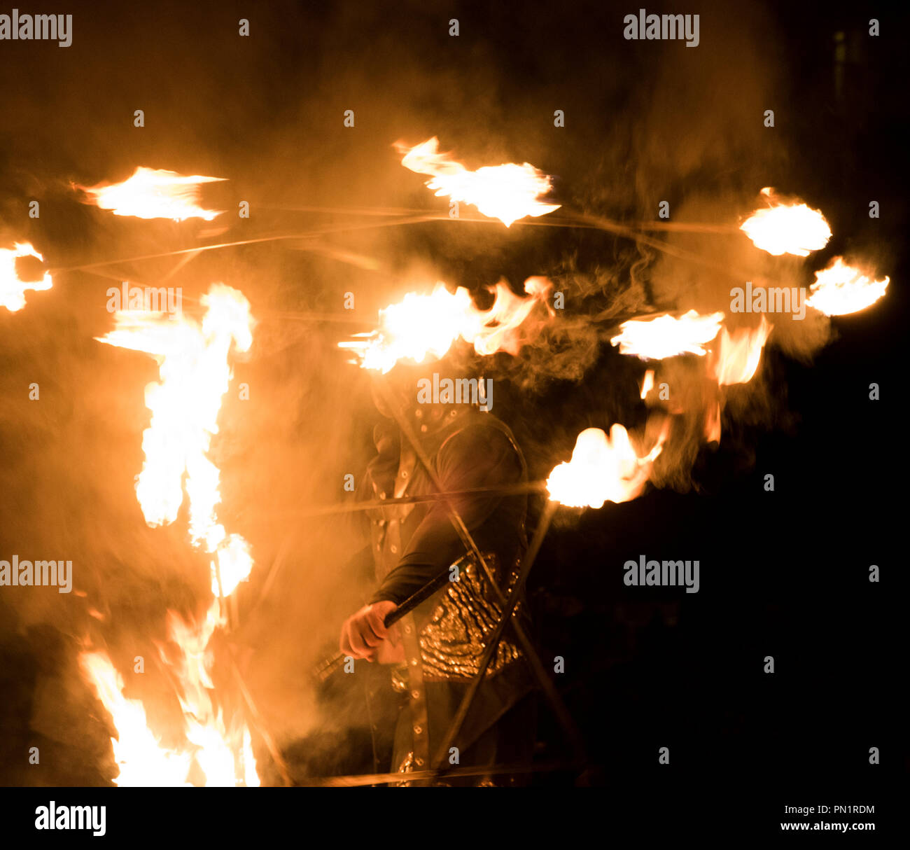 Spinning fire dancer at night Stock Photo - Alamy