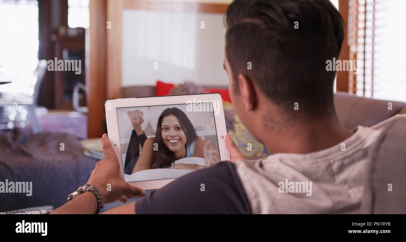 Millennial man video chatting or having a facetime conversation with ...