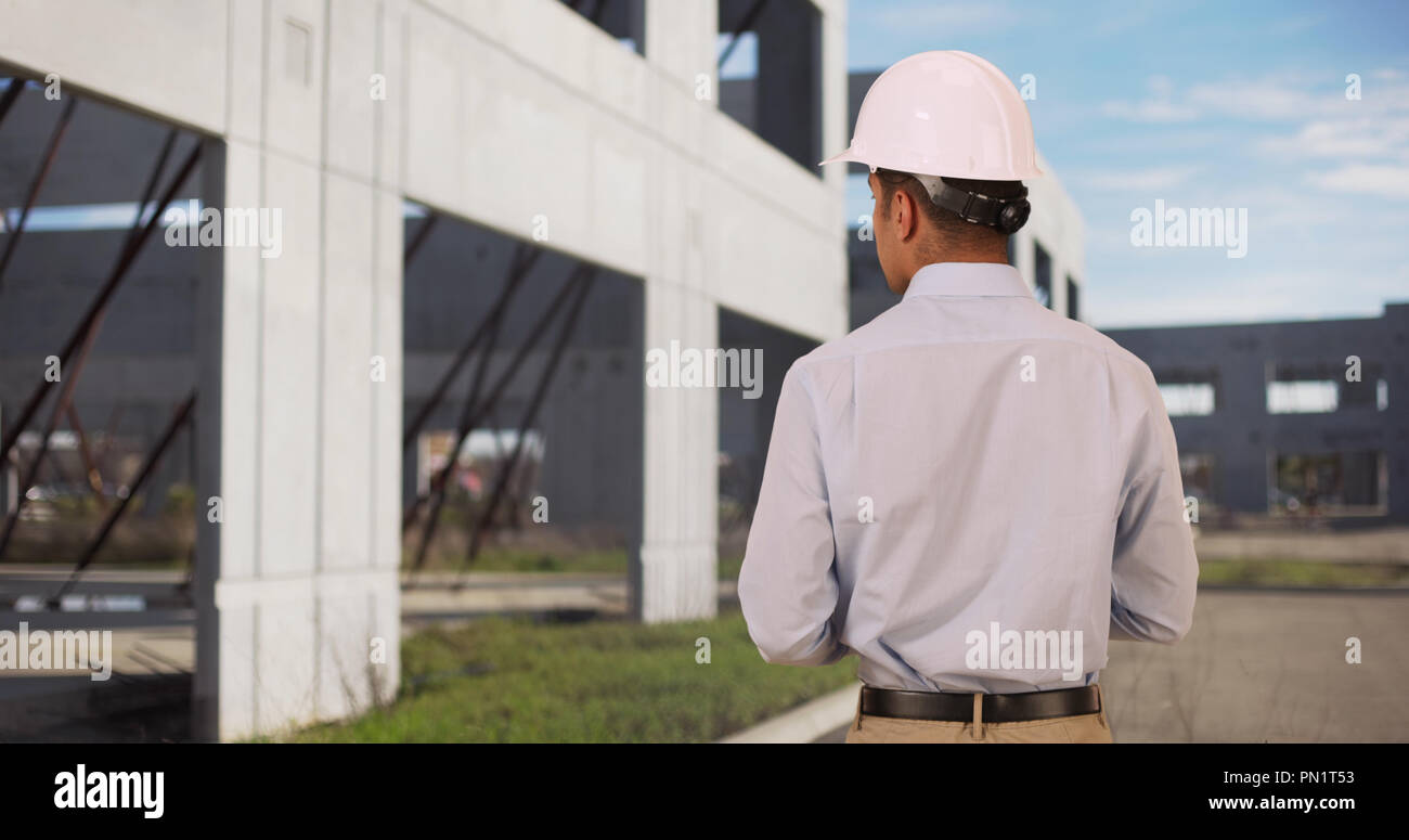 Rear view of handsome and serious architect at construction site Stock ...