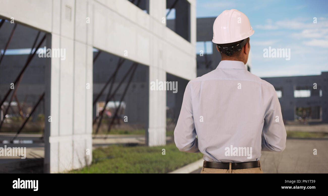 Rear view of handsome and serious architect at construction site Stock ...