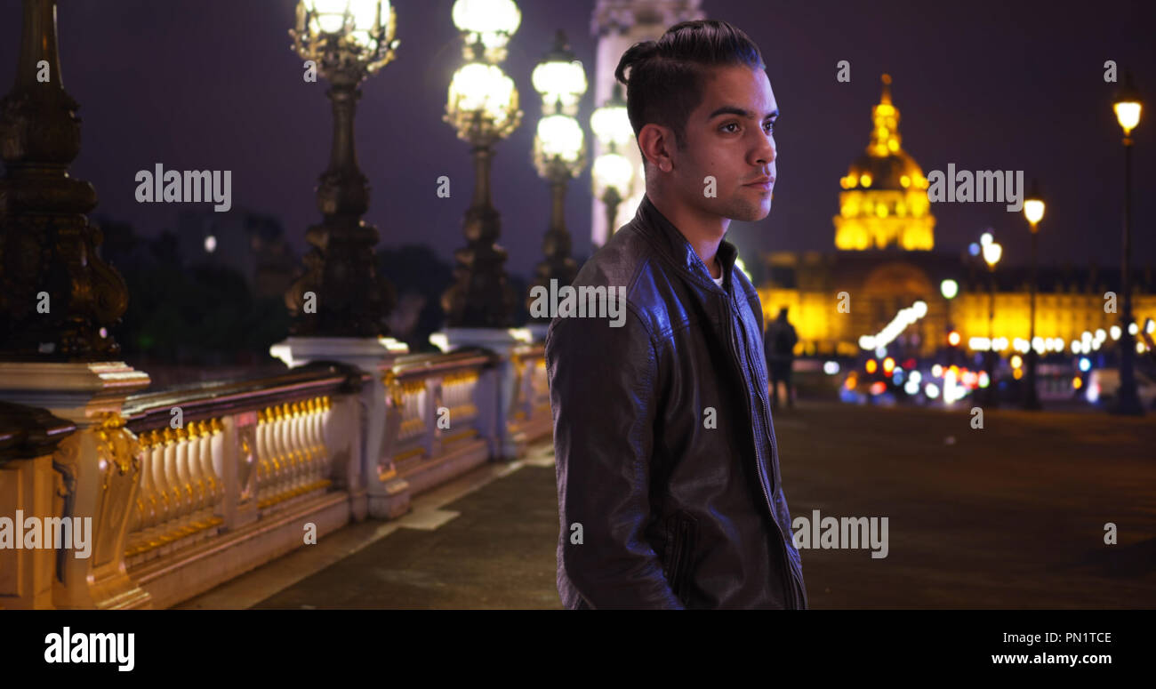 Millennial guy standing on Pont Alexandre III bridge on beautiful night ...