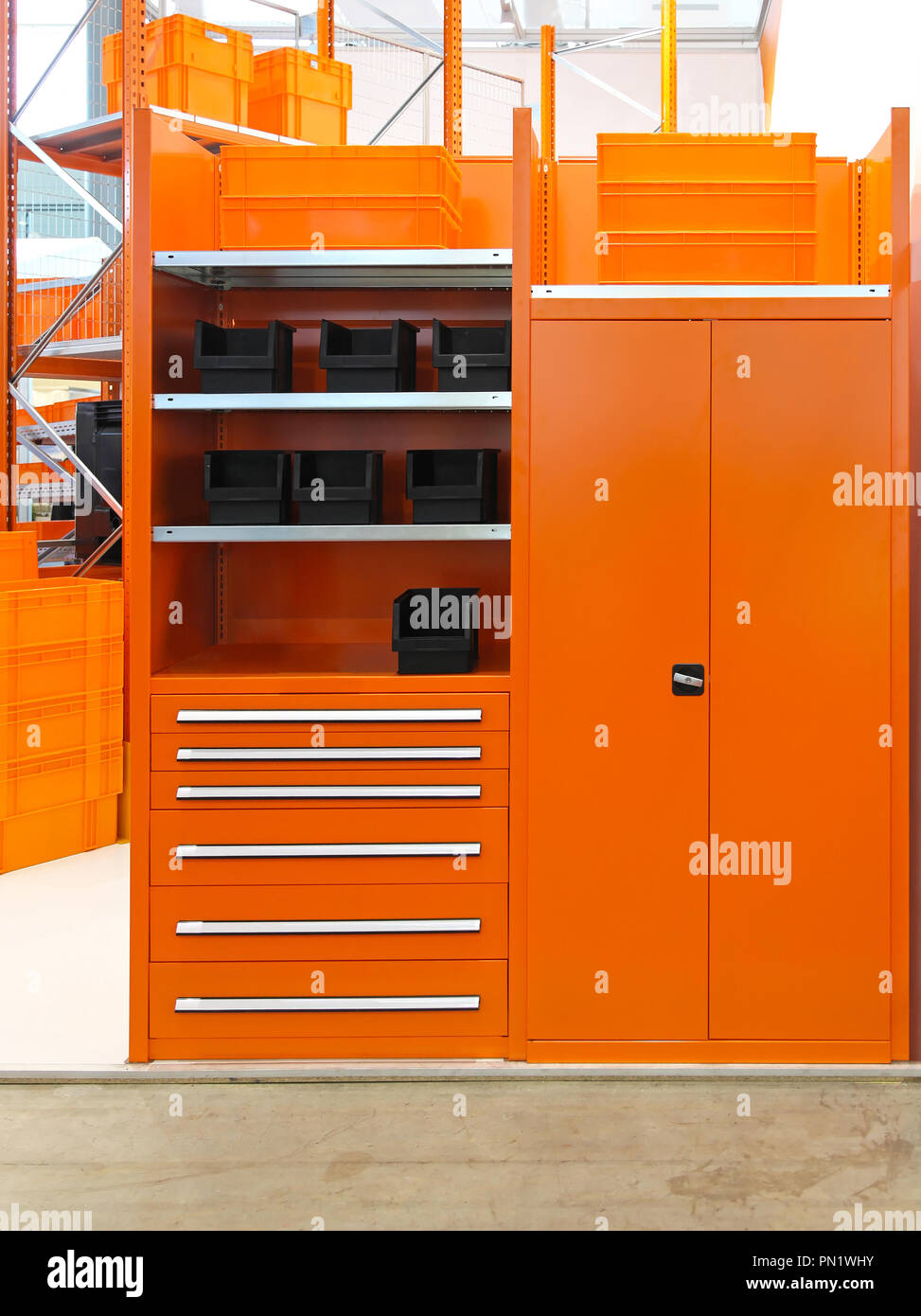 Orange shelves and locker storage in warehouse Stock Photo - Alamy