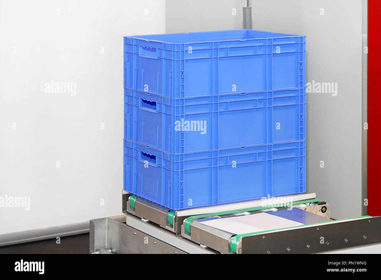 Plastic crates at conveyor belt in factory Stock Photo - Alamy