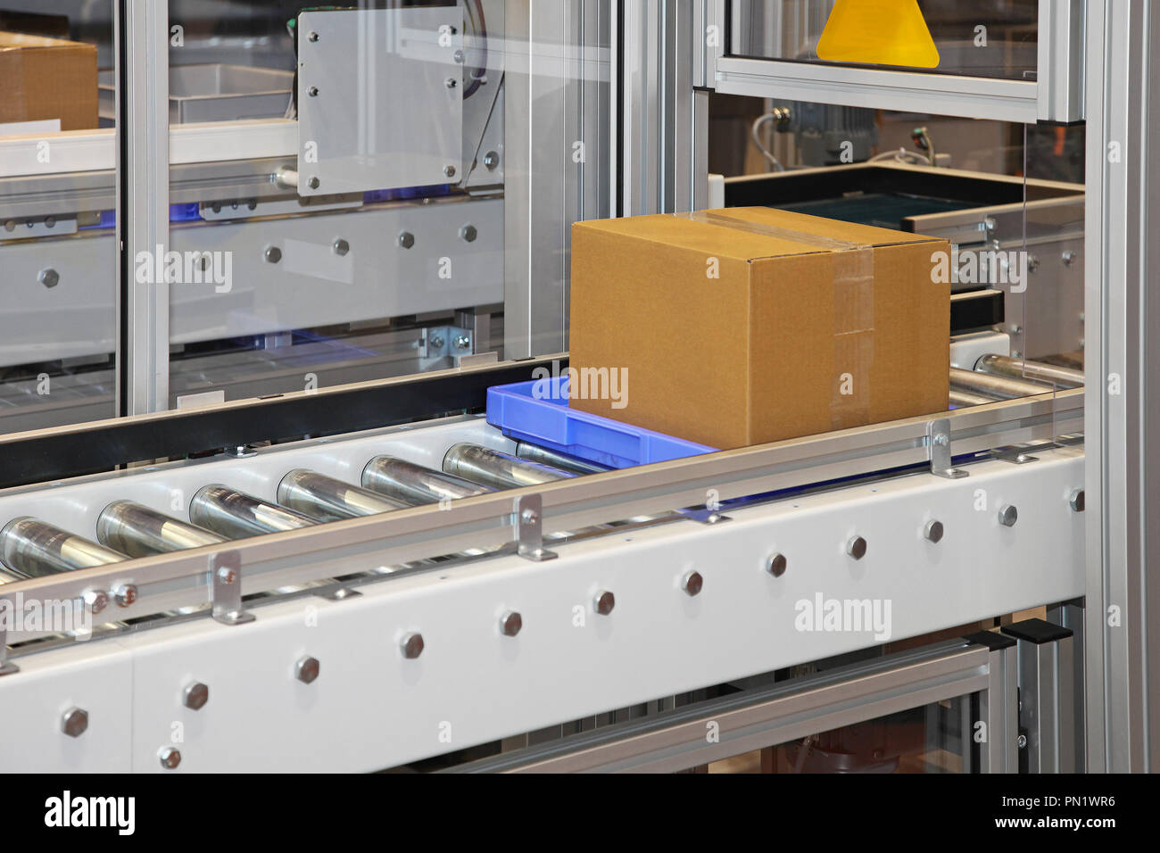 Carboard box at conveyor rollers in factory Stock Photo - Alamy