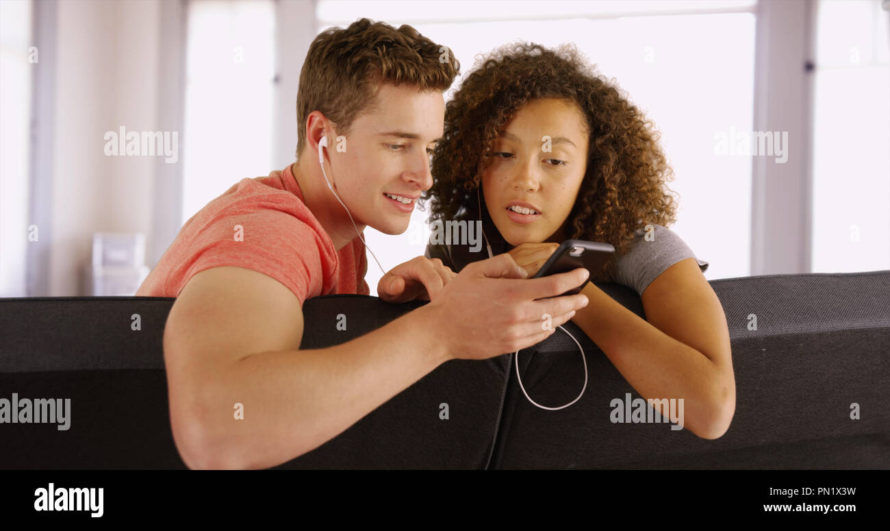 Couple sharing earbuds hi-res stock photography and images - Alamy