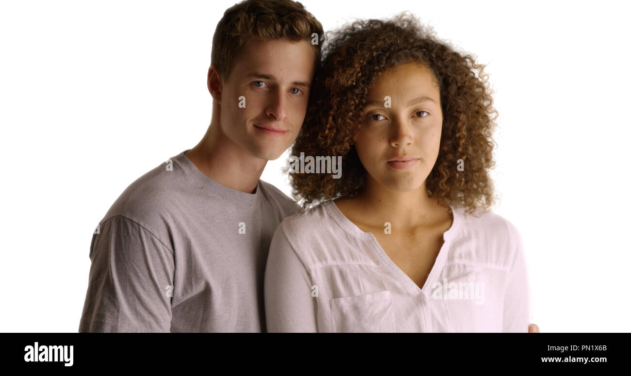 Happy millennial couple pose for a portrait on white background for ...