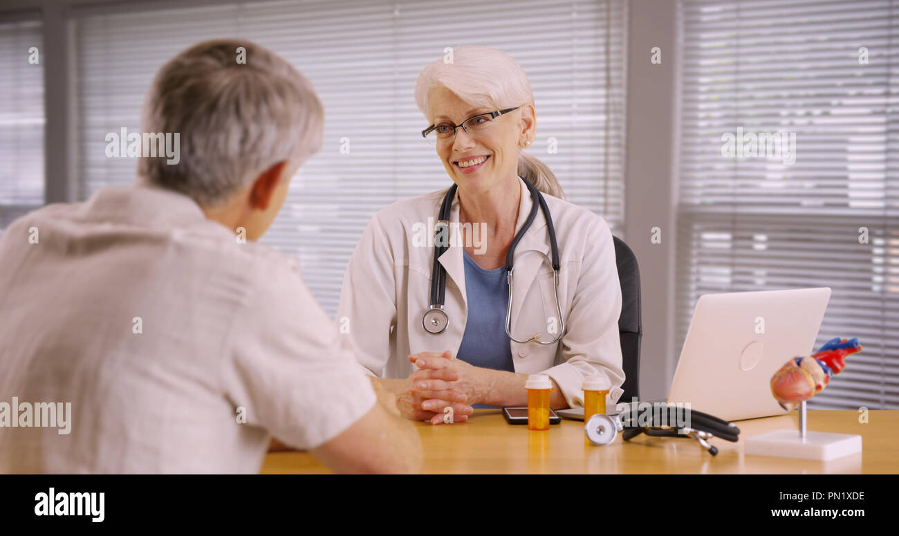 Female doctor prescribing medication senior hi-res stock photography ...