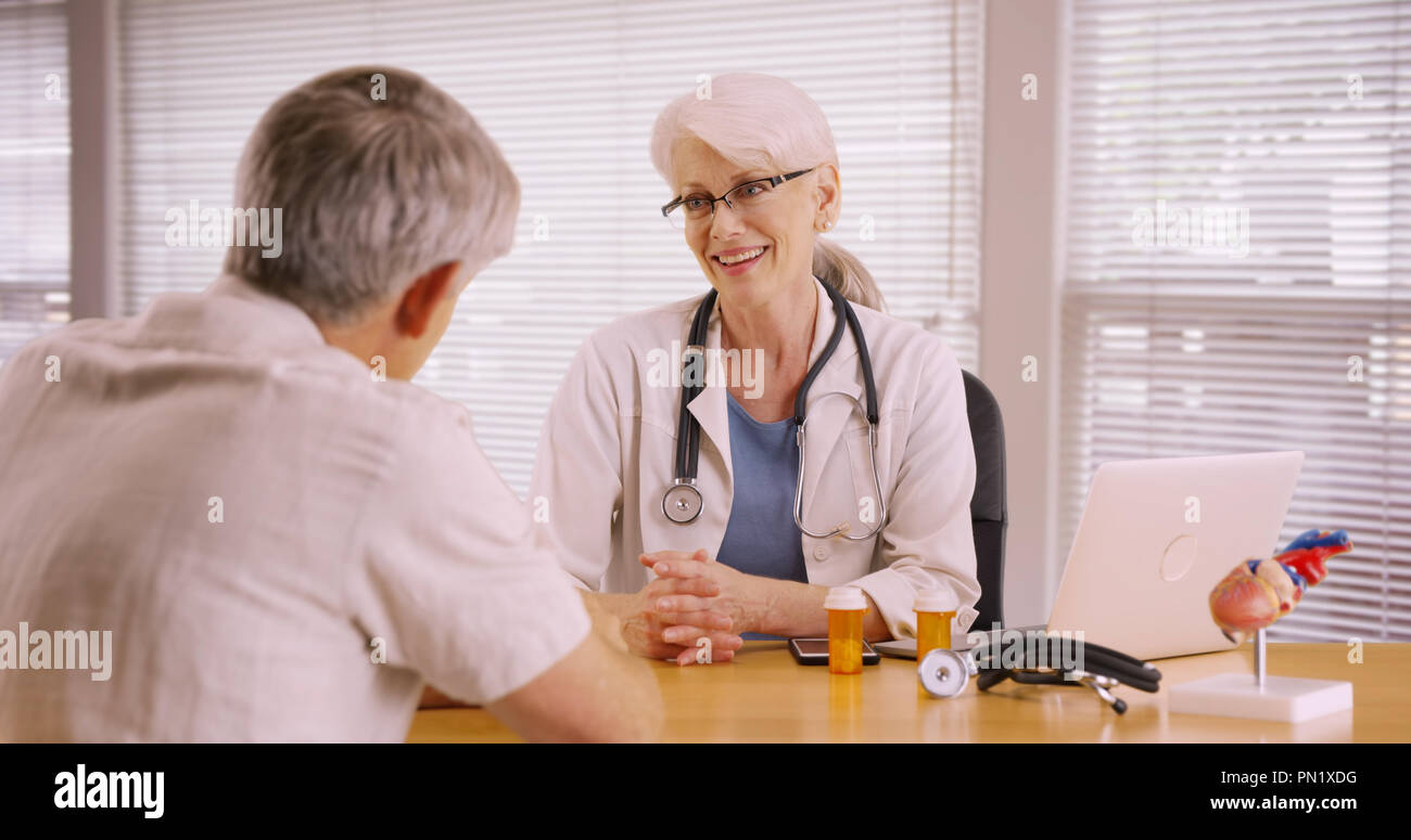 Woman doctor prescribing medication elderly hi-res stock photography ...