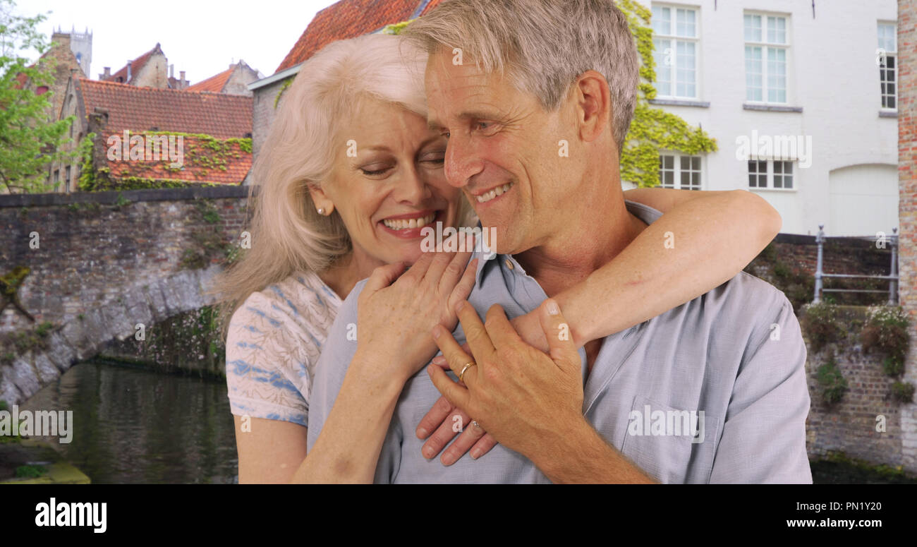 Affectionate husband and wife embracing outdoors Stock Photo - Alamy