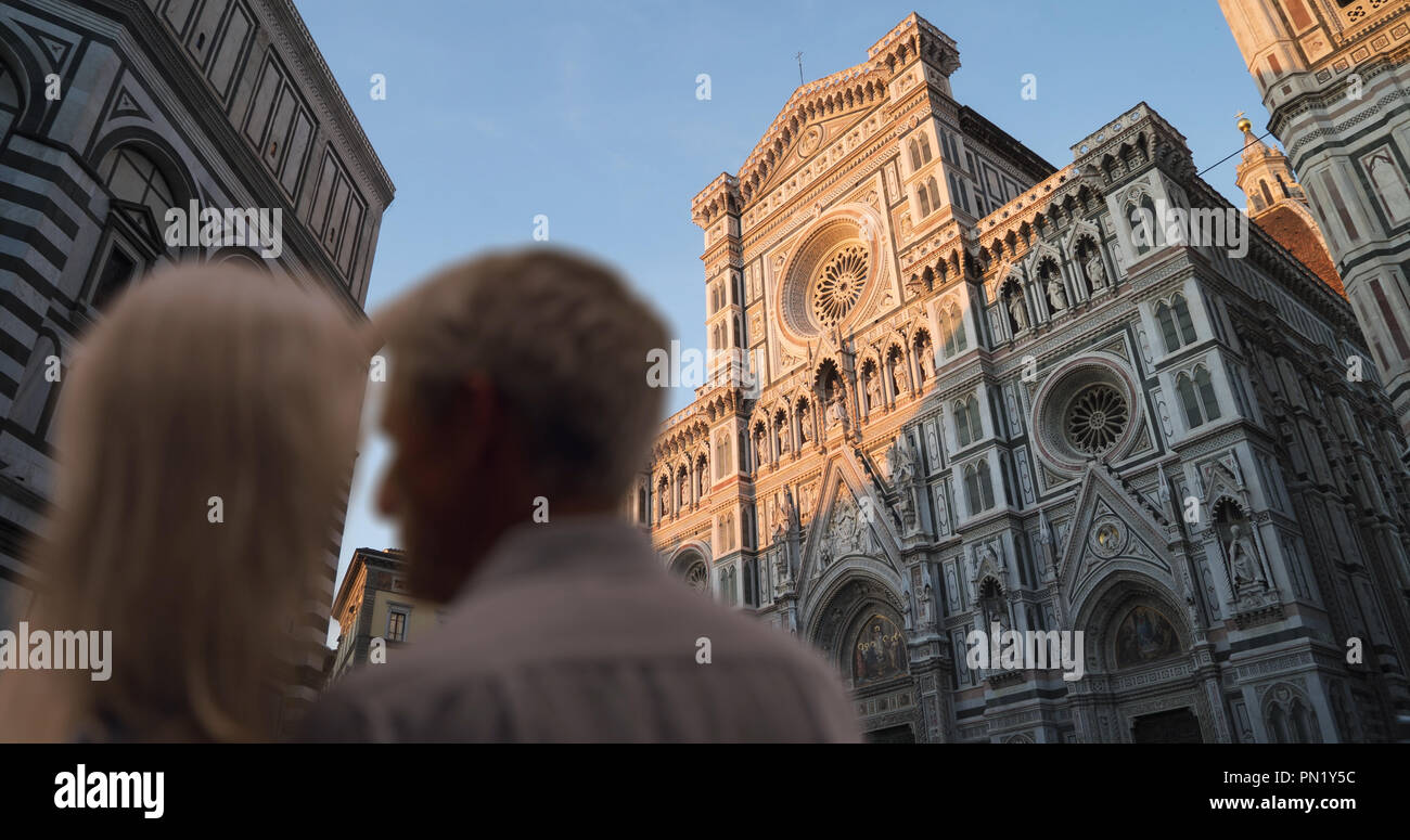 Rear view of mature couple gazing at the Florence Cathedral Stock Photo ...