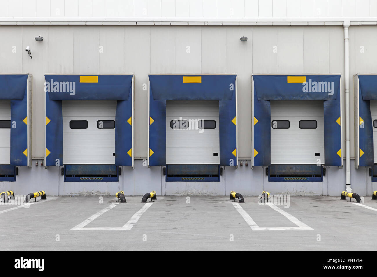 Three loading ramp doors at distribution center Stock Photo - Alamy