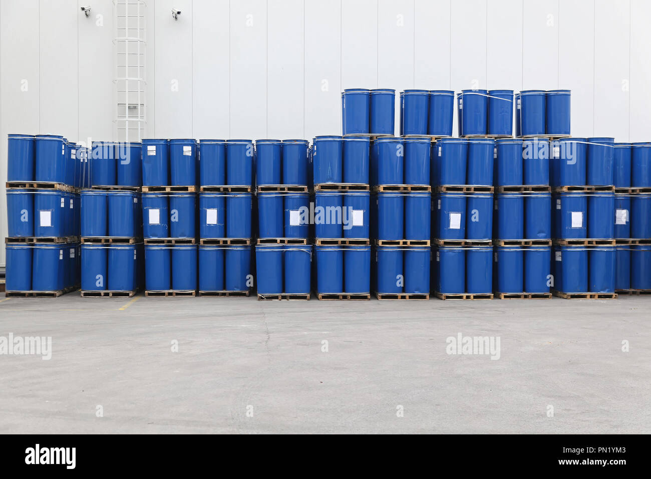 Stack of blue barrels in chemical factory Stock Photo - Alamy