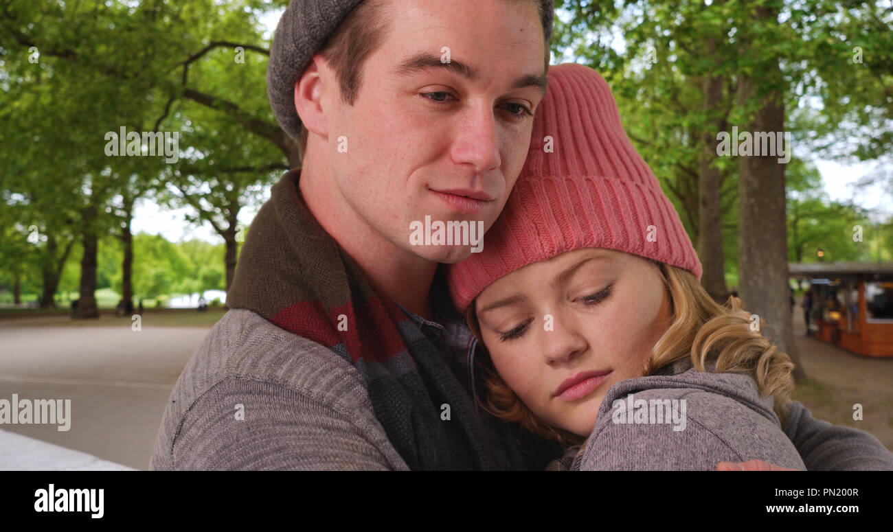 Attractive millennial couple hugging hi-res stock photography and ...