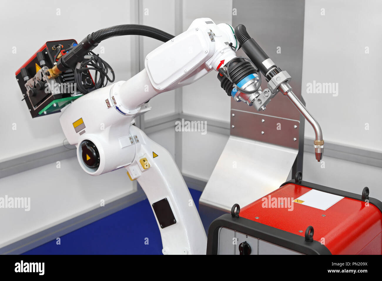 White robotic arm for welding in factory Stock Photo - Alamy