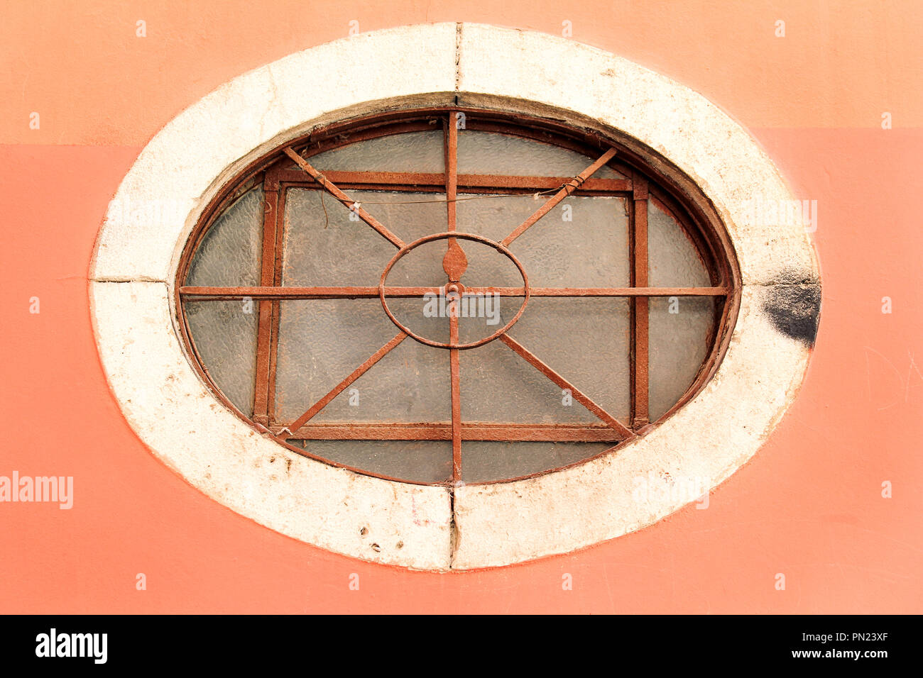 Round window with iron bars. Old ancient metal window. Round and arched ...