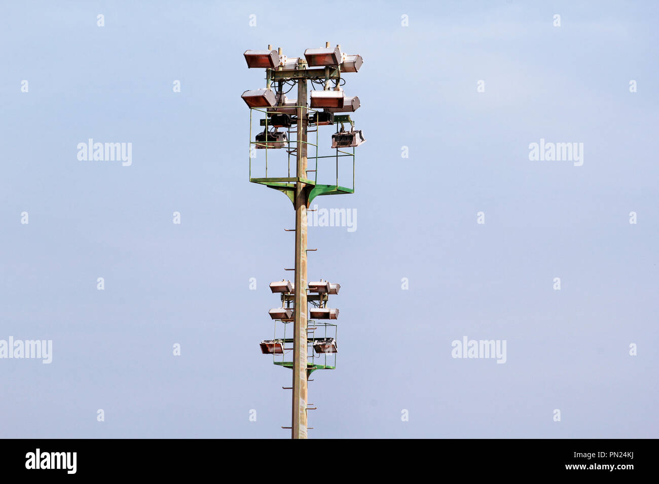 Stadium floodlight tower with reflectors with blue sky. Lighting pole ...