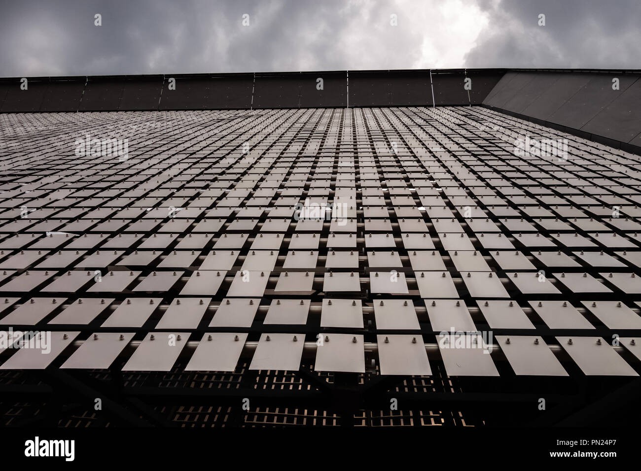 Kinetic facade of the building. Metal plates in brushed stainless steel ...