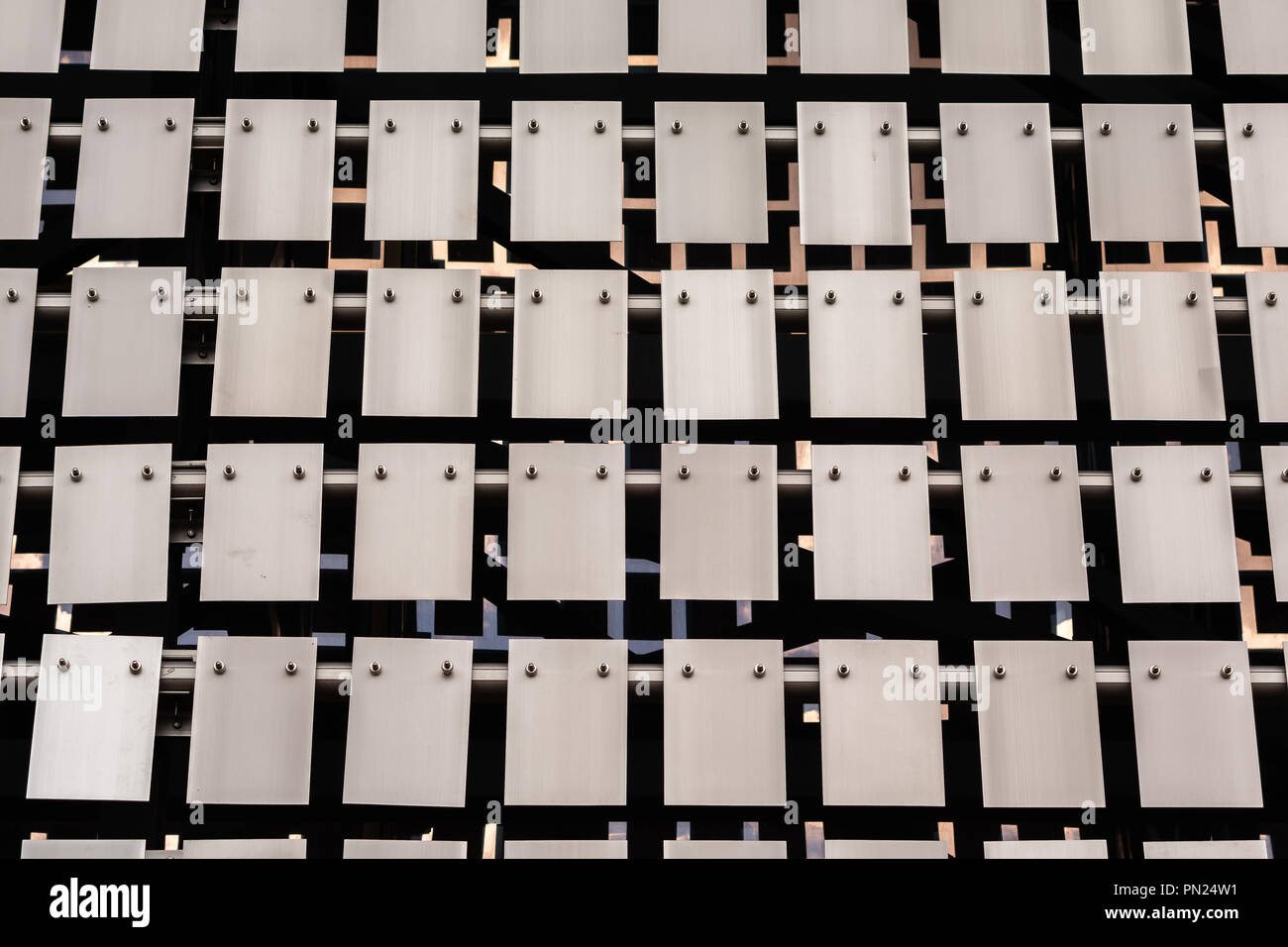 Kinetic facade of the building. Metal plates in brushed stainless steel ...