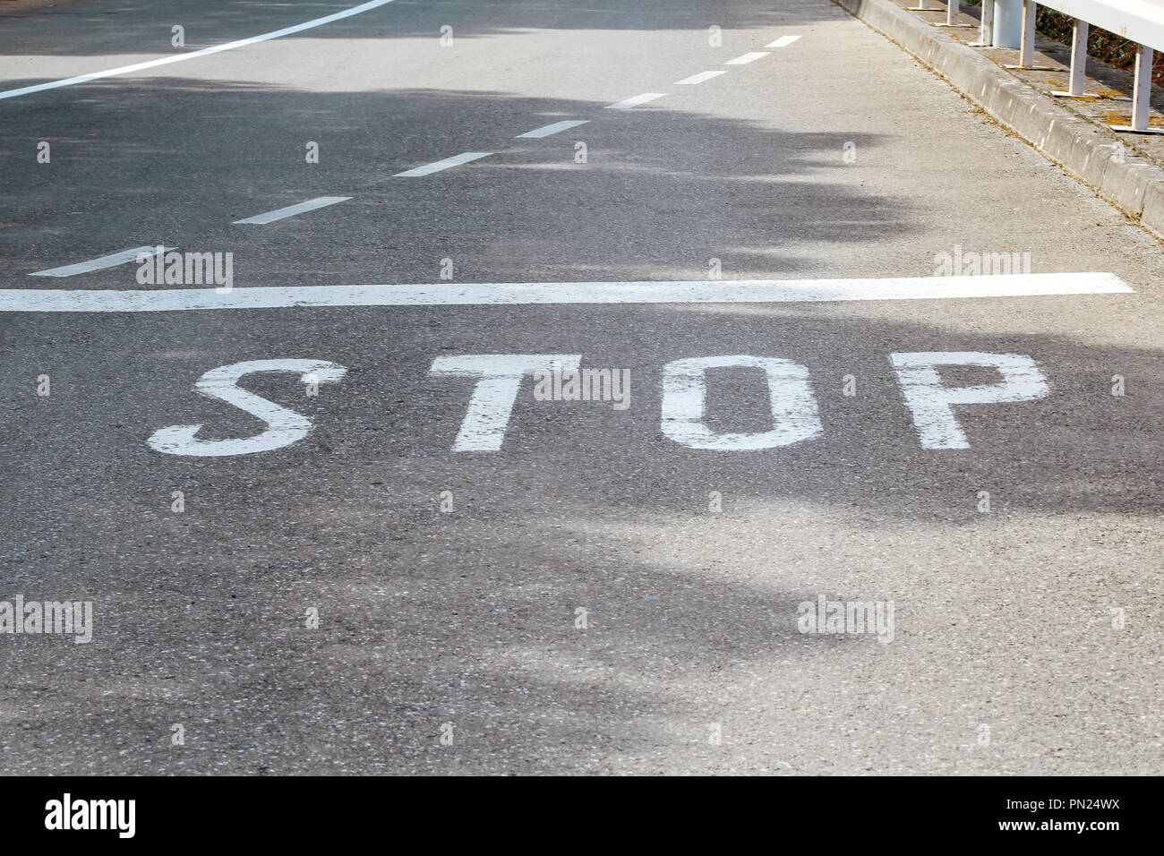 Stop sign on road surface hi-res stock photography and images - Alamy