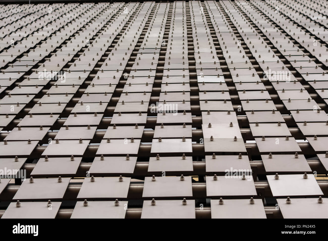 Kinetic facade of the building. Metal plates in brushed stainless steel ...