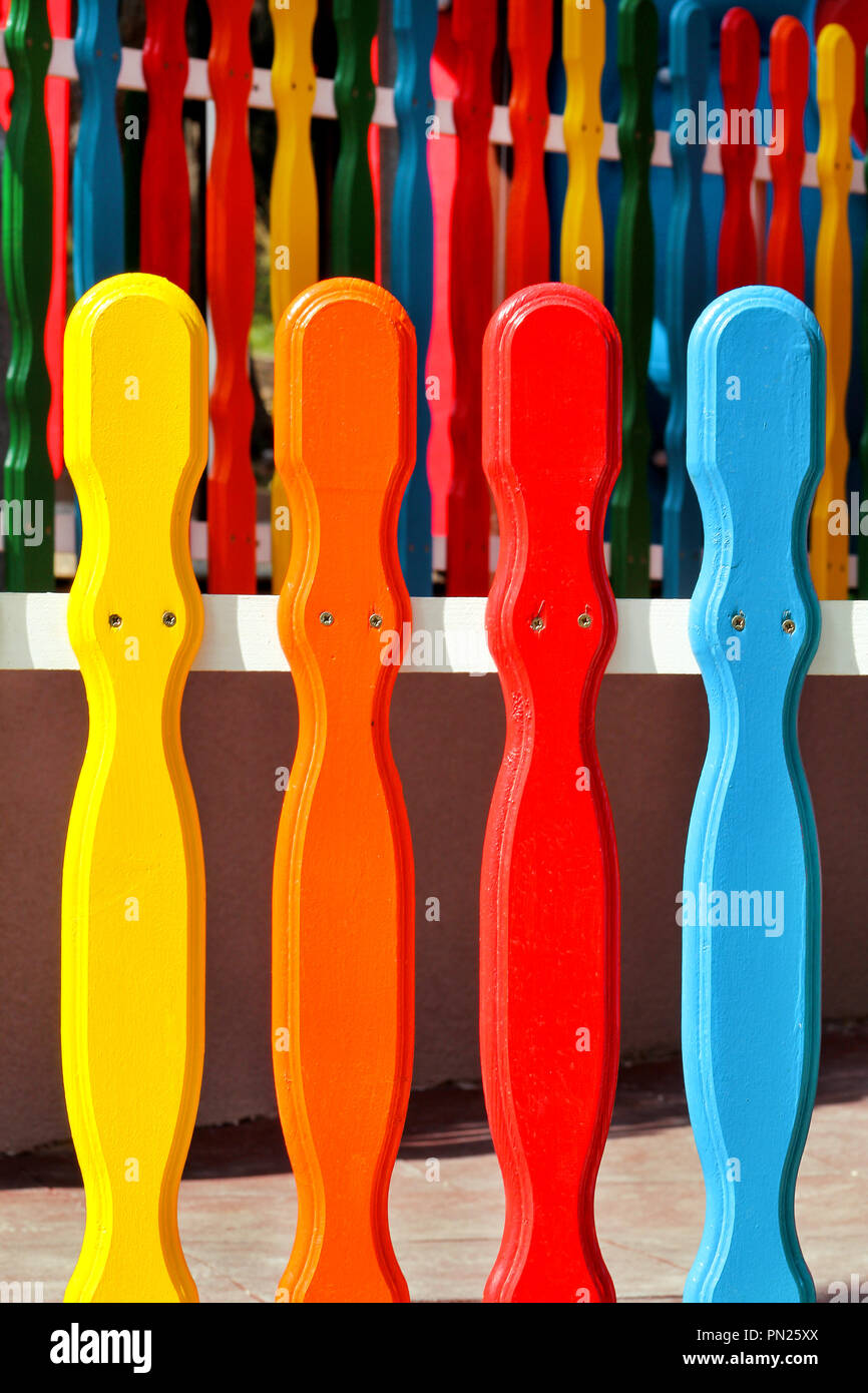 Colorful wooden decorative fence in the park. Colored wooden plank ...