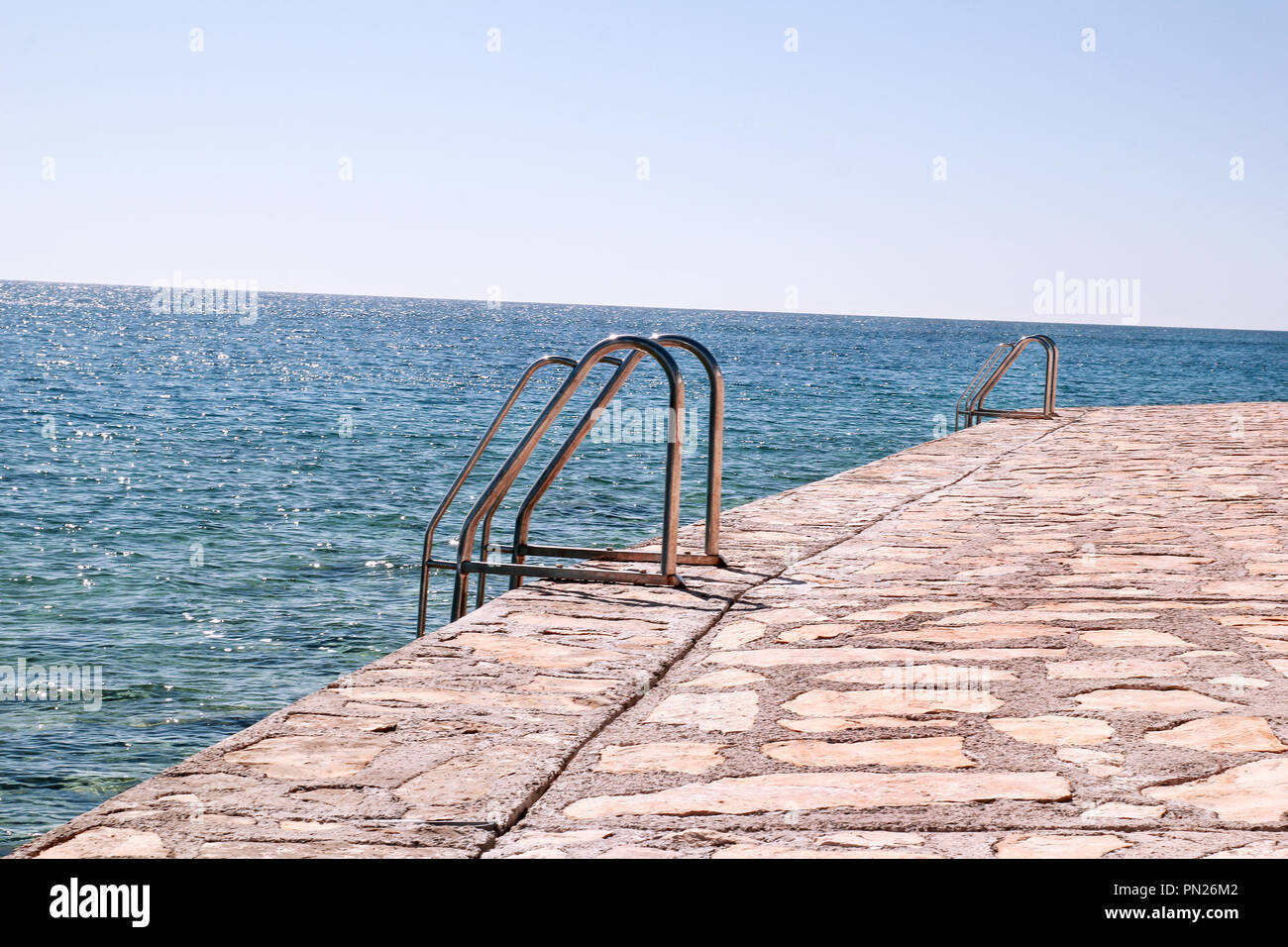 Handrail swimming on the beach of the sea. Steel handrail, swimming ...