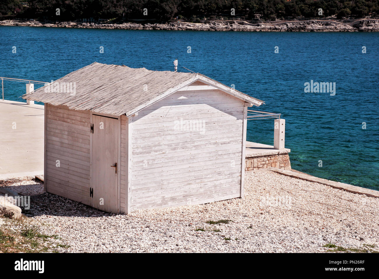 House on beach by the sea. Wooden white hut on empty beach. Summer ...