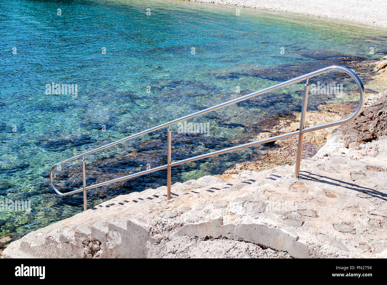 Handrail swimming on the beach of the sea. Steel handrail, swimming ...