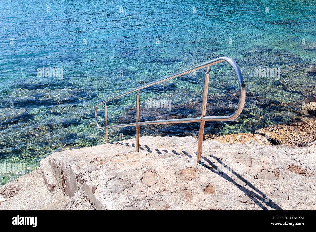 Handrail swimming on the beach of the sea. Steel handrail, swimming ...